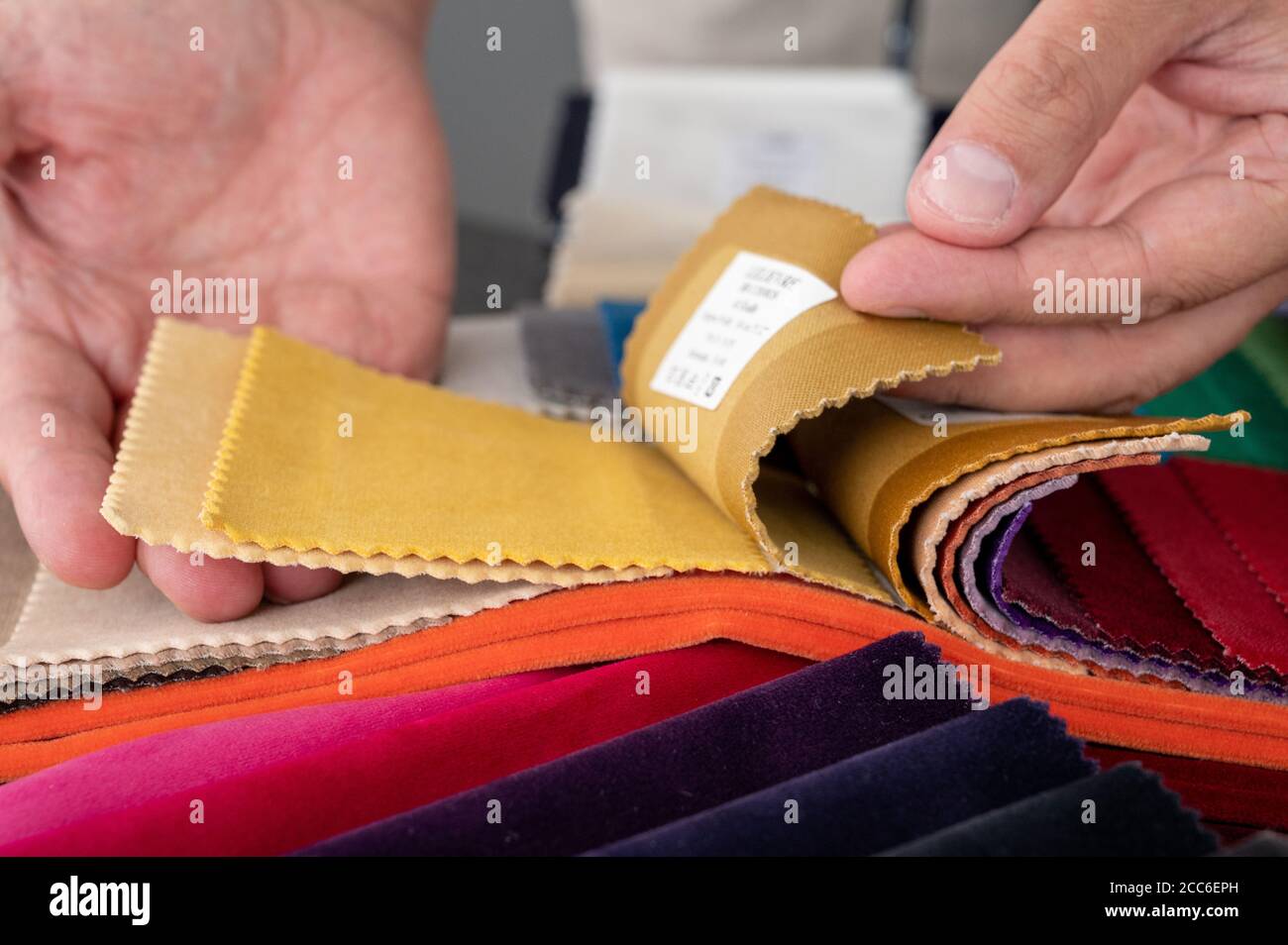 Hands browsing soft velvet samples as part of making the right decision ...