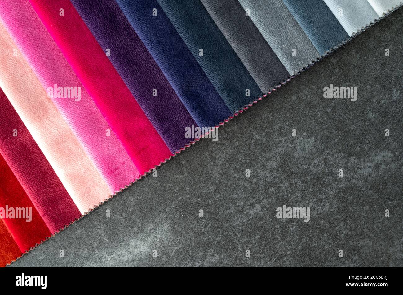 Color gradients of velvet samples on fabric swatch placed on a dark ...