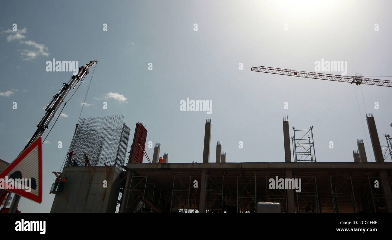 Construction workers working on the construction site Stock Photo - Alamy