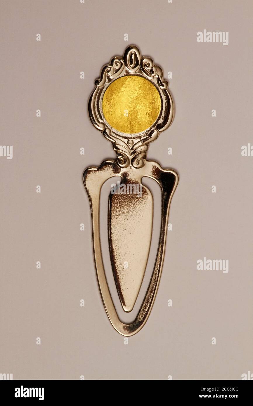 A bookmark made of precious metals such as brass, silver and gold with ...