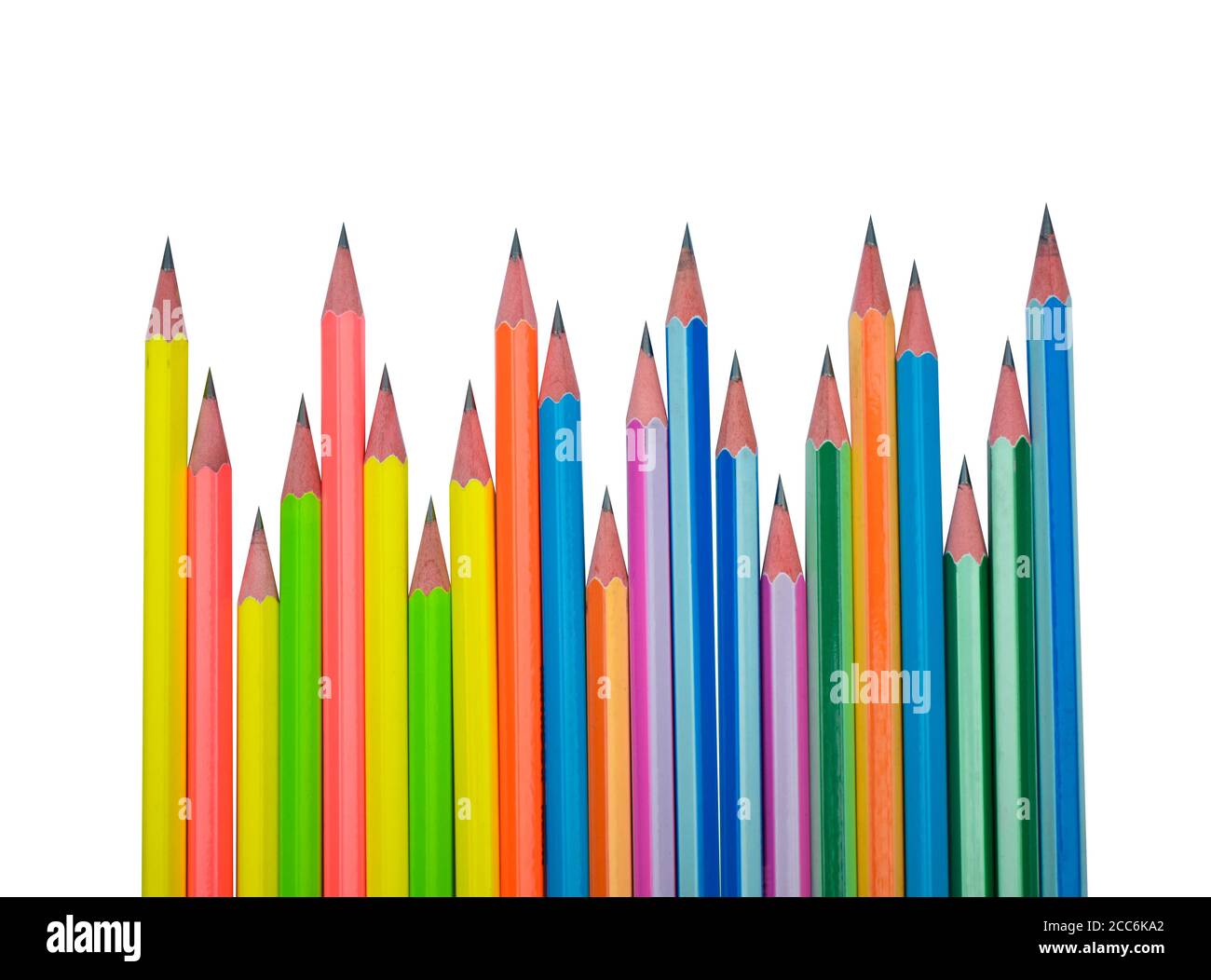 Many different colored wood pencil crayons scattered in a line on a ...