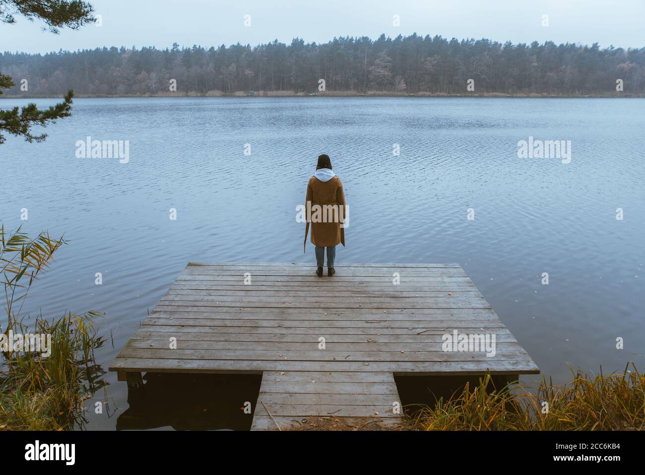 autumn lake season woman in coat at wooden pier Stock Photo - Alamy
