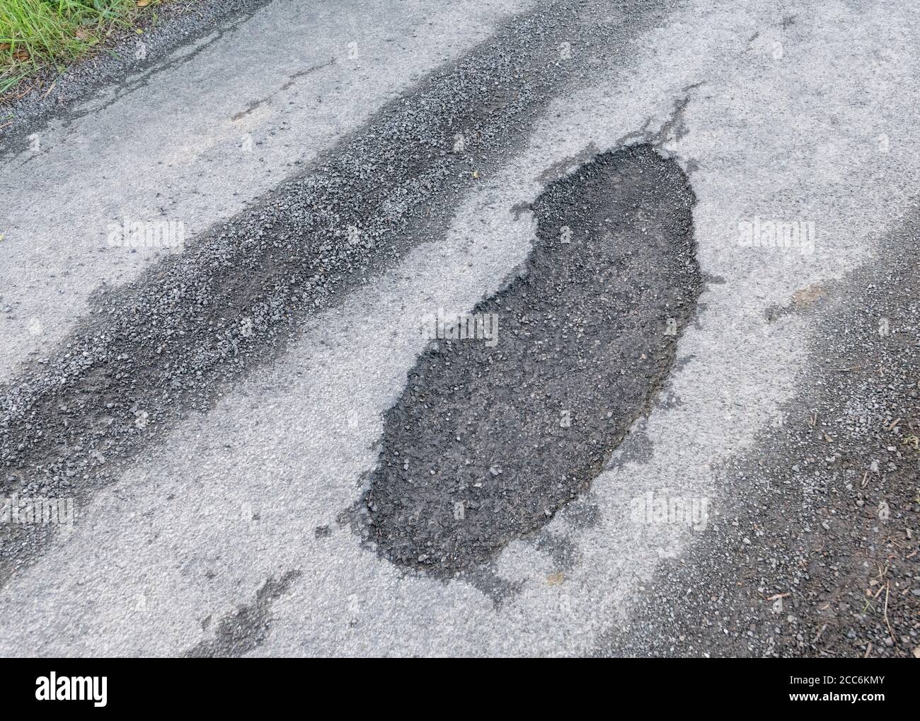 Pothole in road tarmac. For rural potholes, pothole breakdowns on the ...