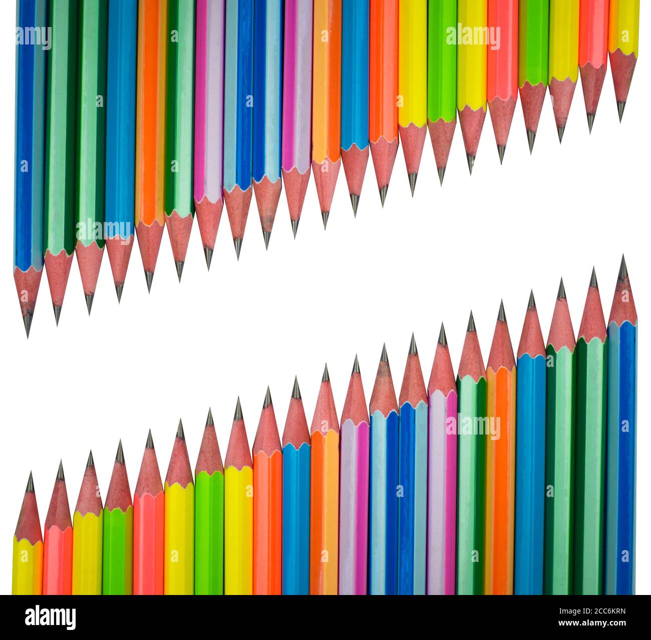 two rows of different colored wood pencil crayons facing each other on ...