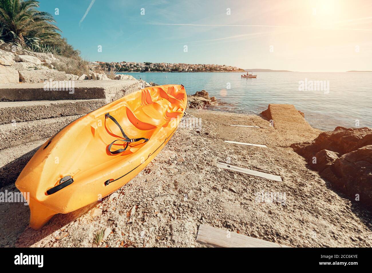 Bright orange kayak is on the stone sea pier Stock Photo - Alamy