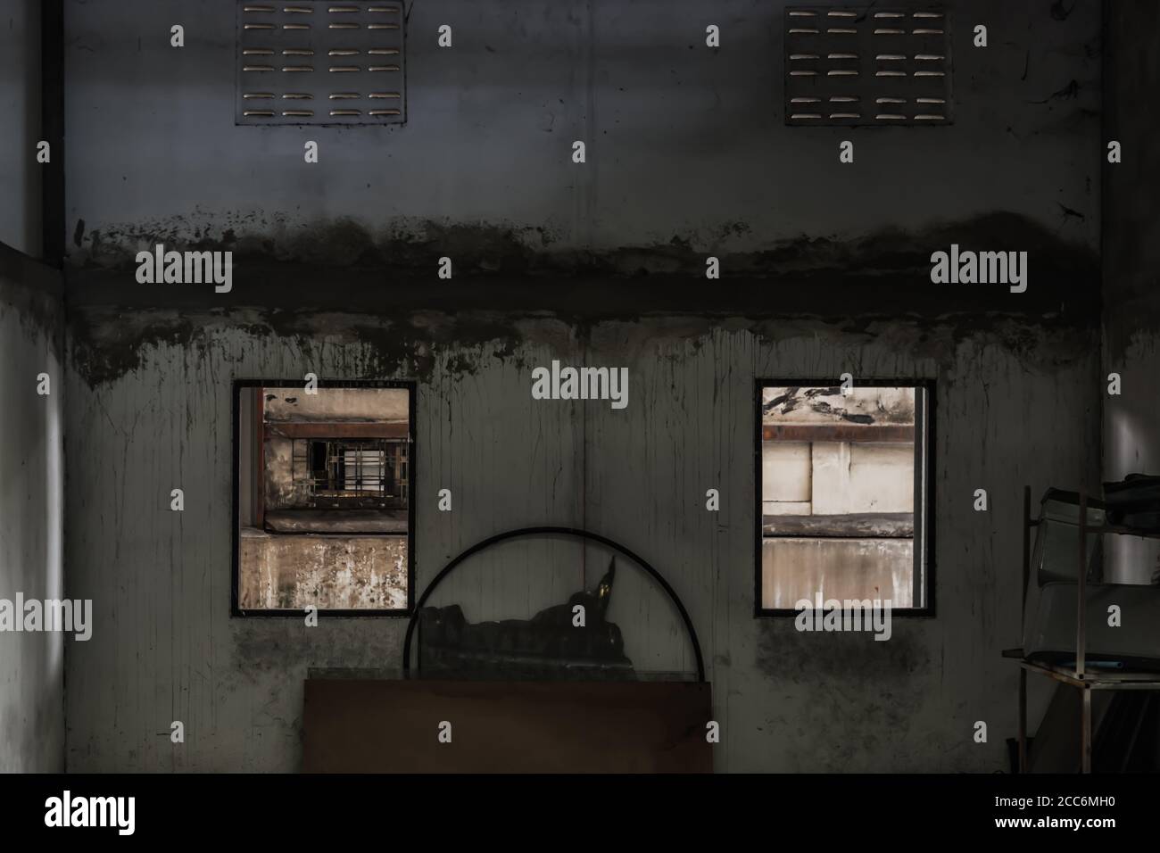 Abandoned room with two window was left to deteriorate over time ...