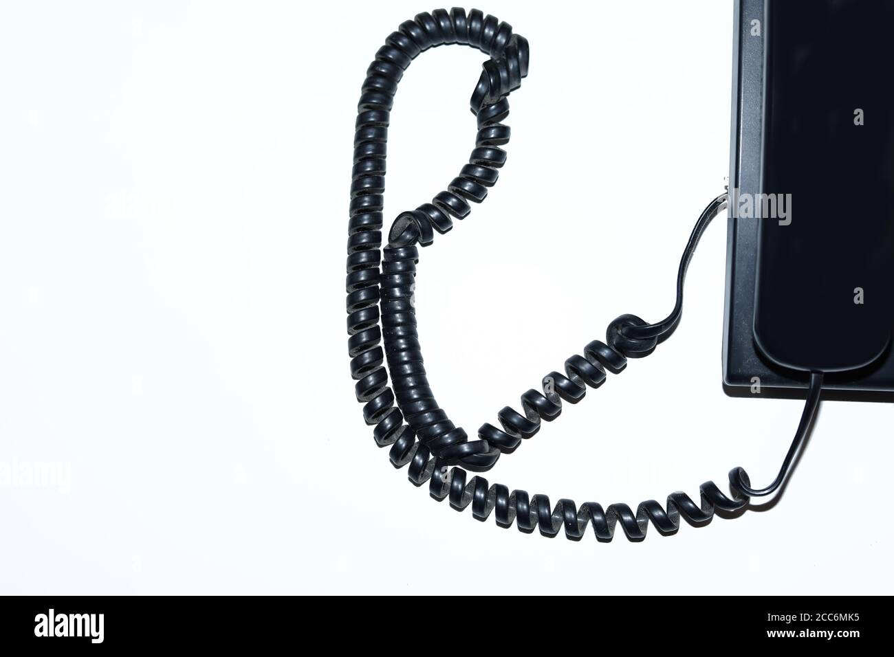 Black old fashioned telephone receiver isolated on a white backgrounds ...