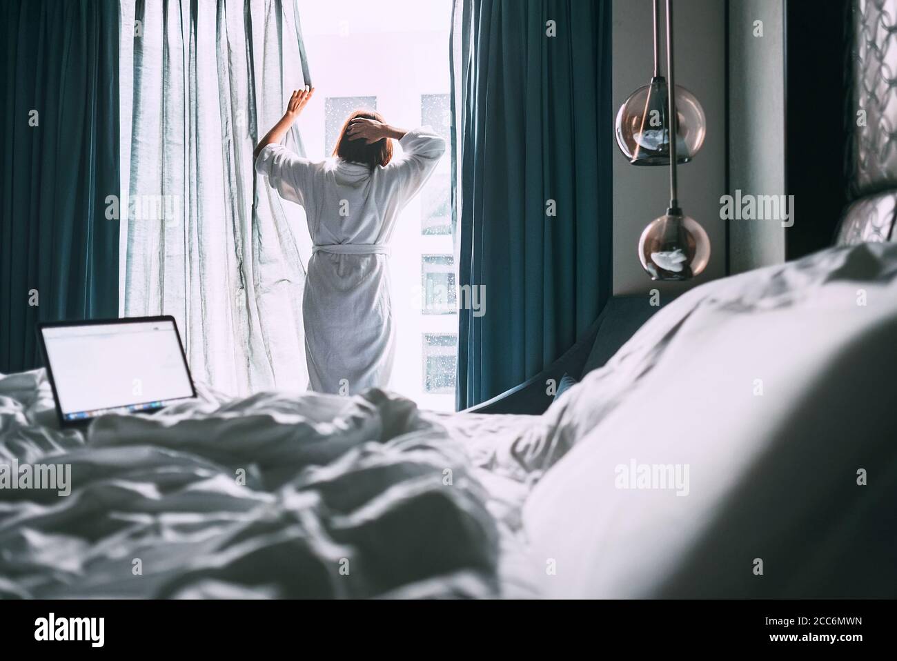 Woman wakes up in luxury hotel room Stock Photo - Alamy
