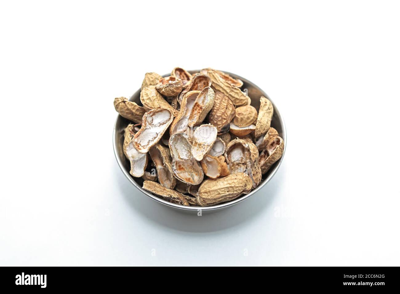 Shell peanuts in a silver bowl on a white backgrounds Stock Photo - Alamy