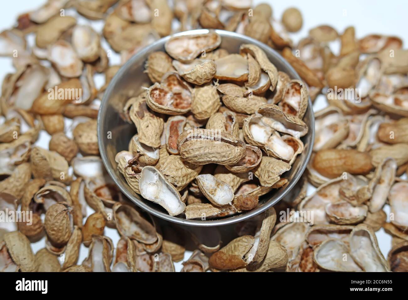 Shell peanuts in a silver bowl on a white backgrounds Stock Photo - Alamy