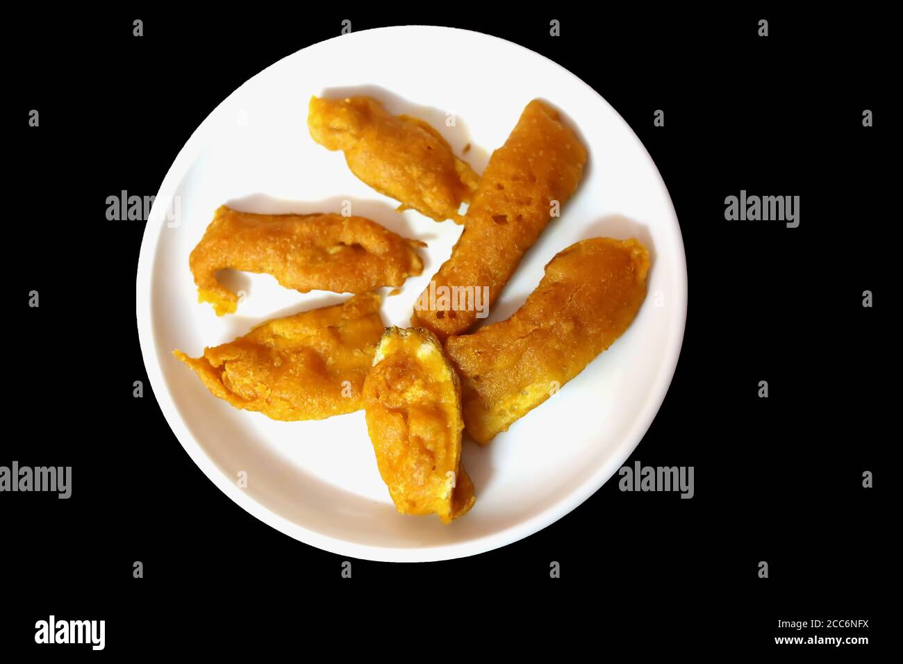 South Indian Potato Snack, Vazhakkai Bajji served on black backgrounds ...