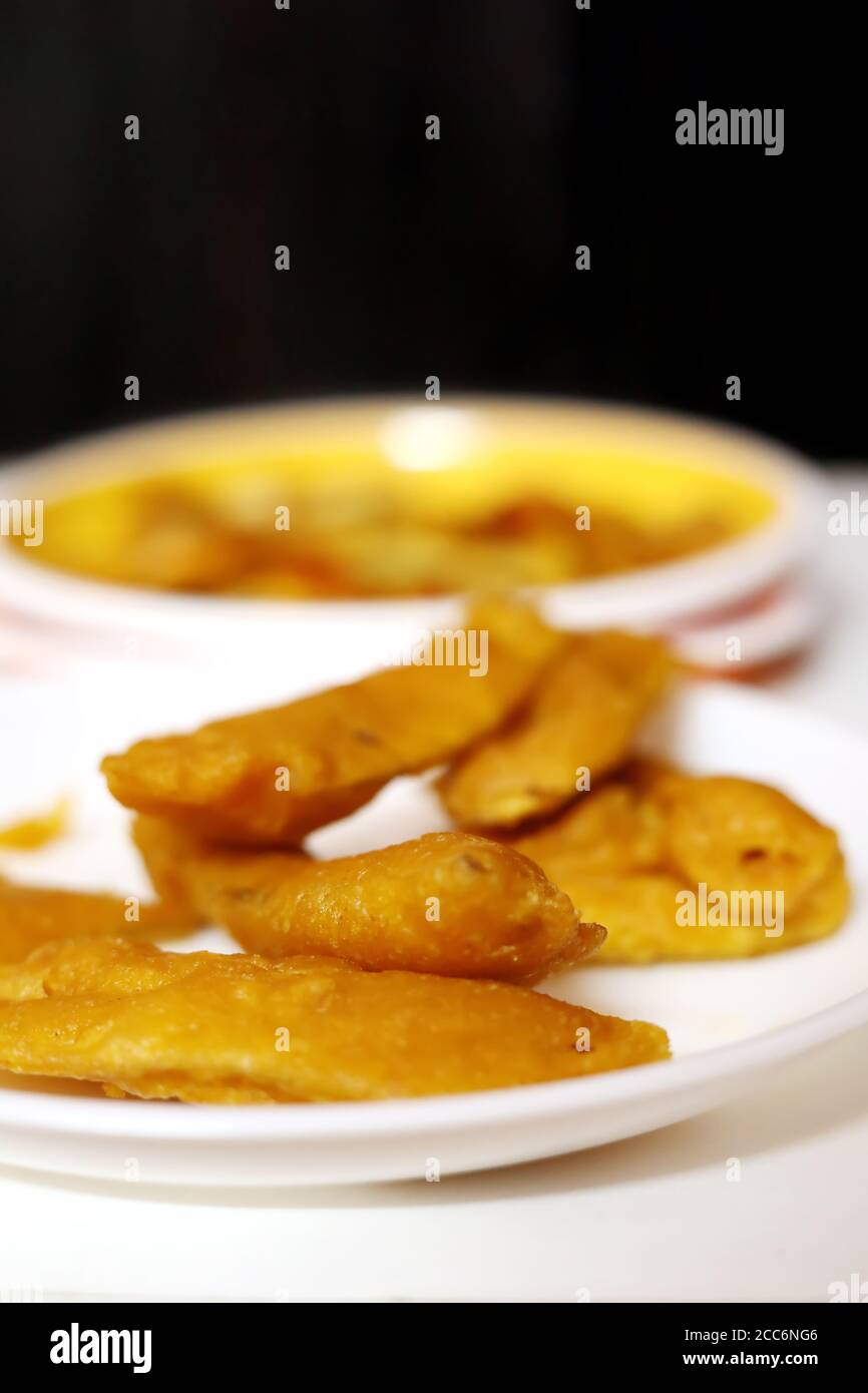 South Indian Potato Snack, Vazhakkai Bajji served on black backgrounds ...