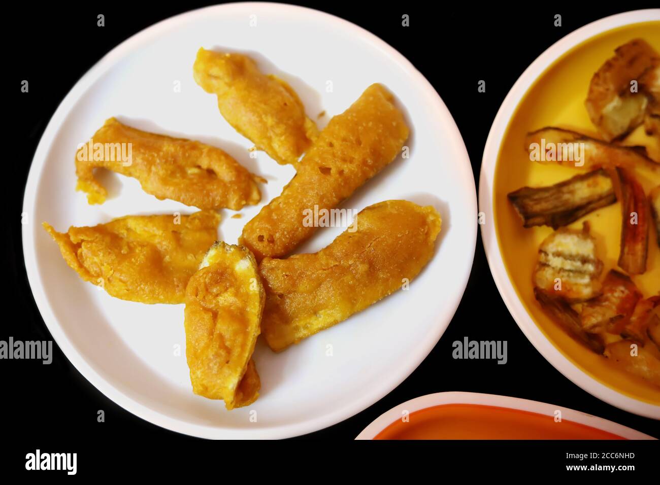 South Indian Potato Snack, Vazhakkai Bajji served on black backgrounds ...