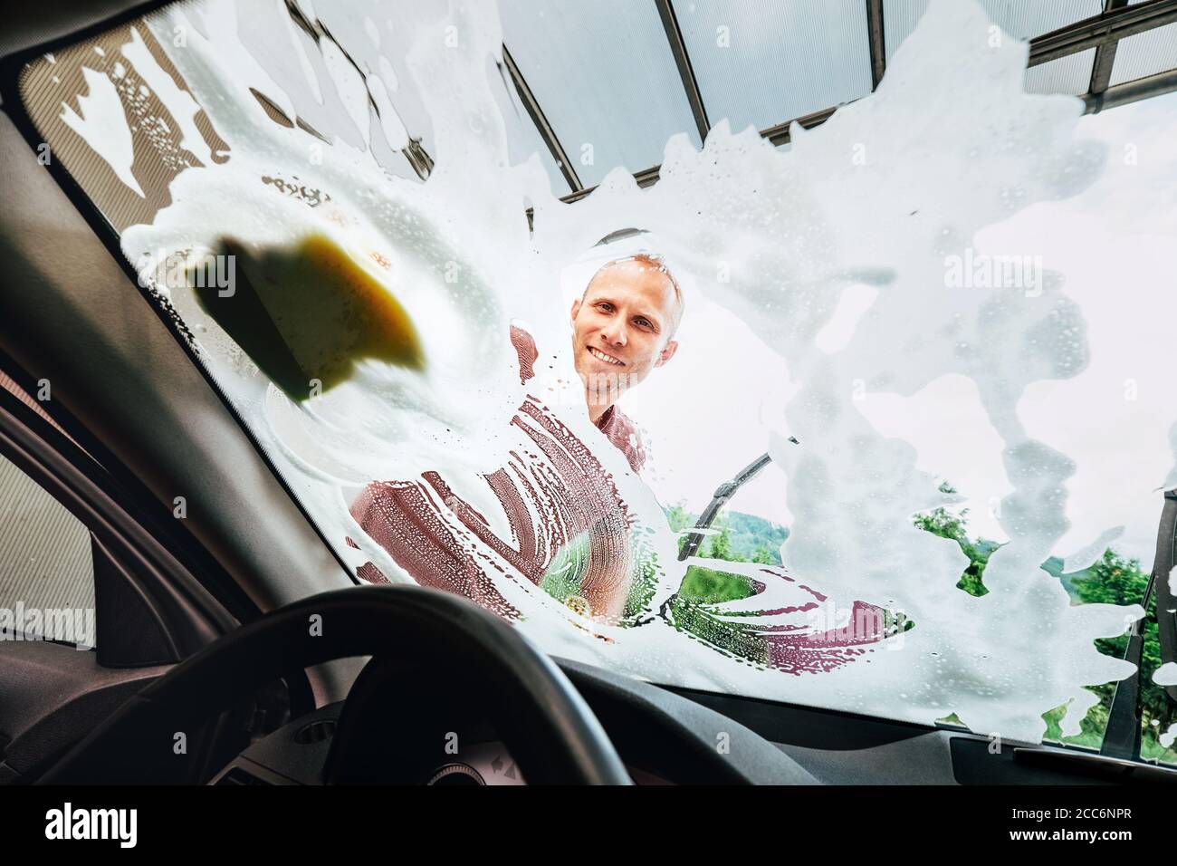 Young man washing windows hi-res stock photography and images - Alamy