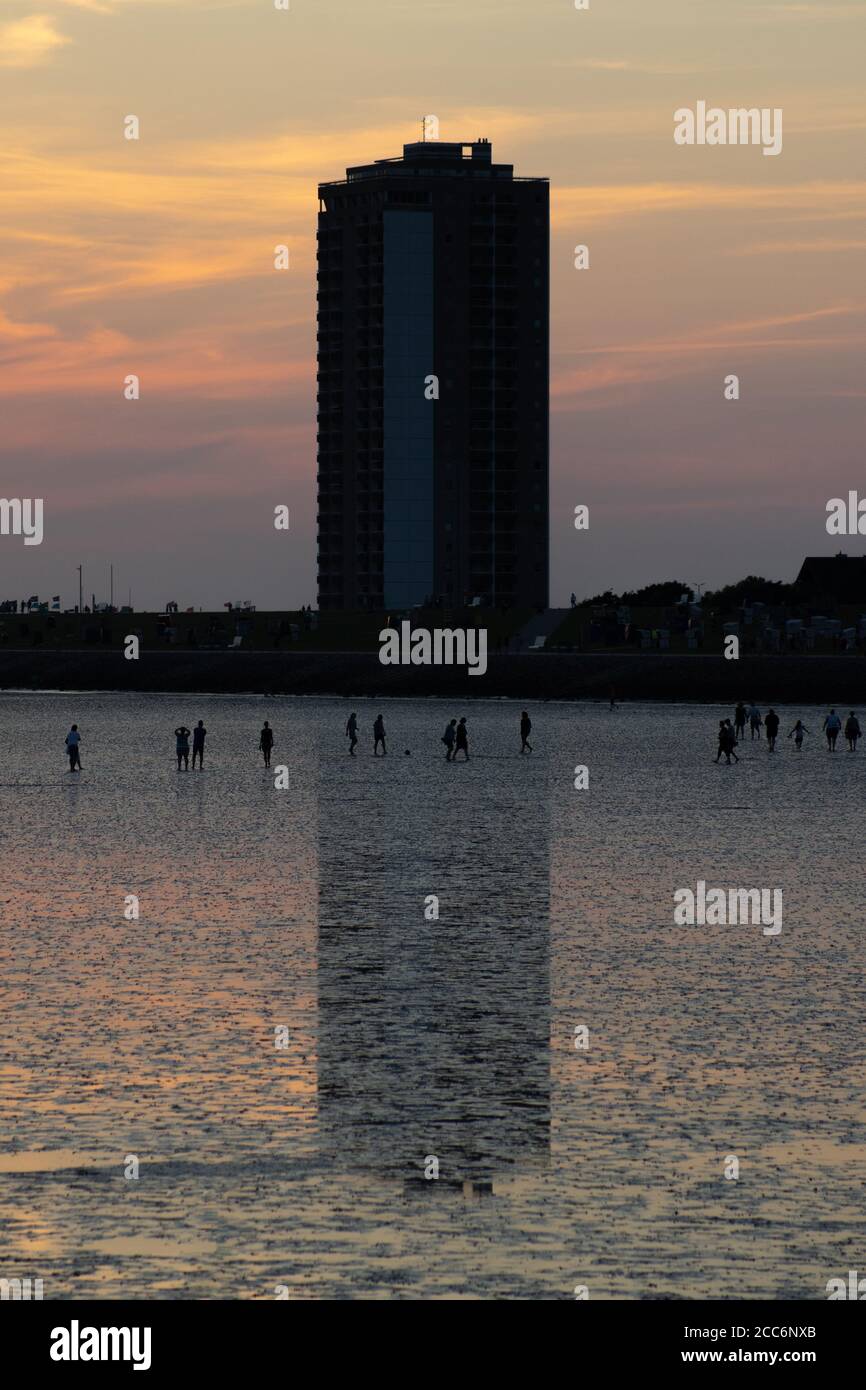 Reflection of an apartment house in the wet mudflats off Buesum in the ...