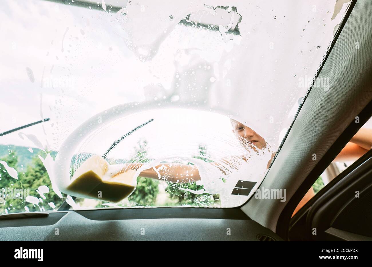 Boy helps to wash a car. Inside car camera view Stock Photo - Alamy