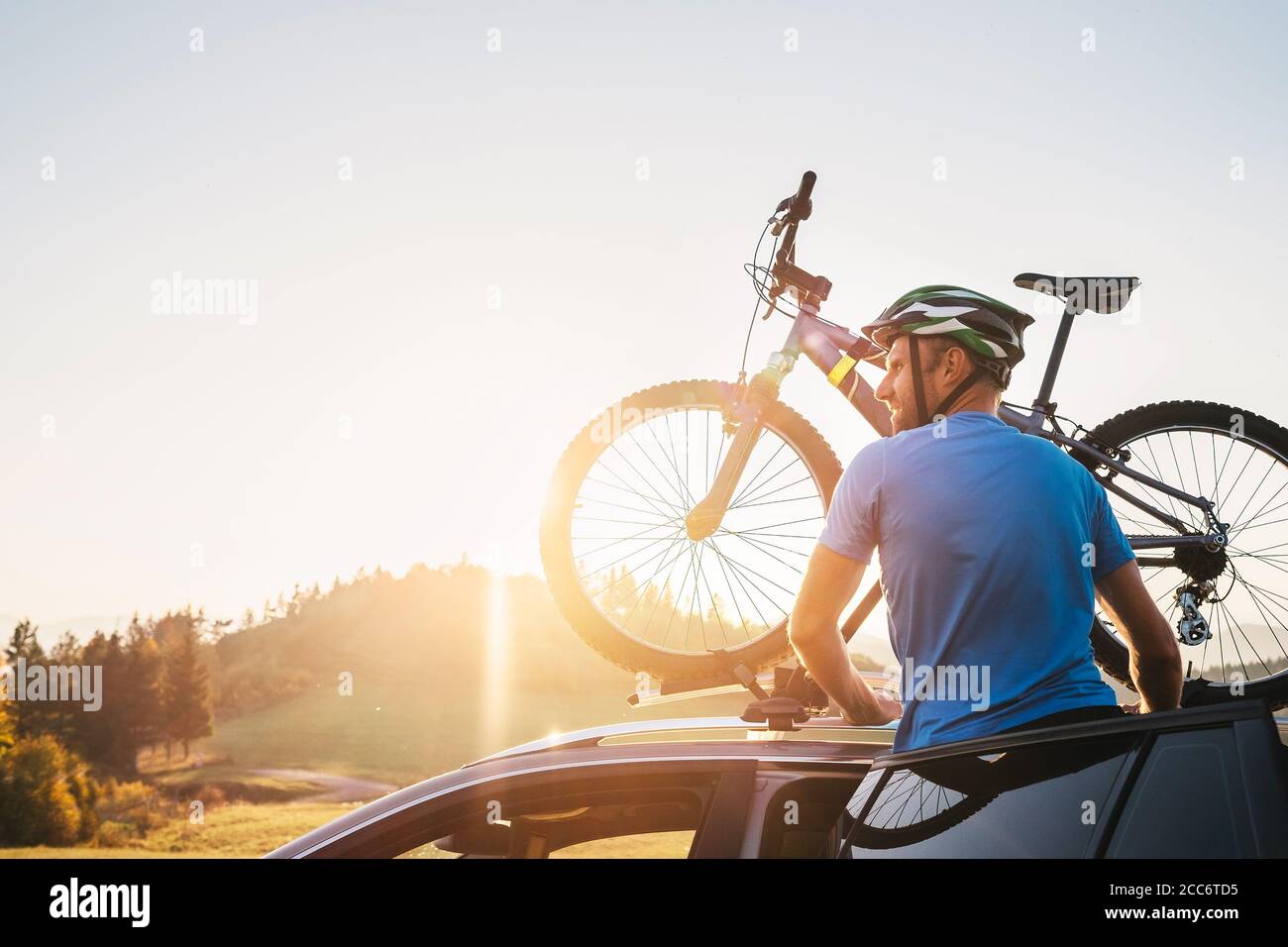 Man take his bicycle from car roof. Mountain biking concept Stock Photo ...