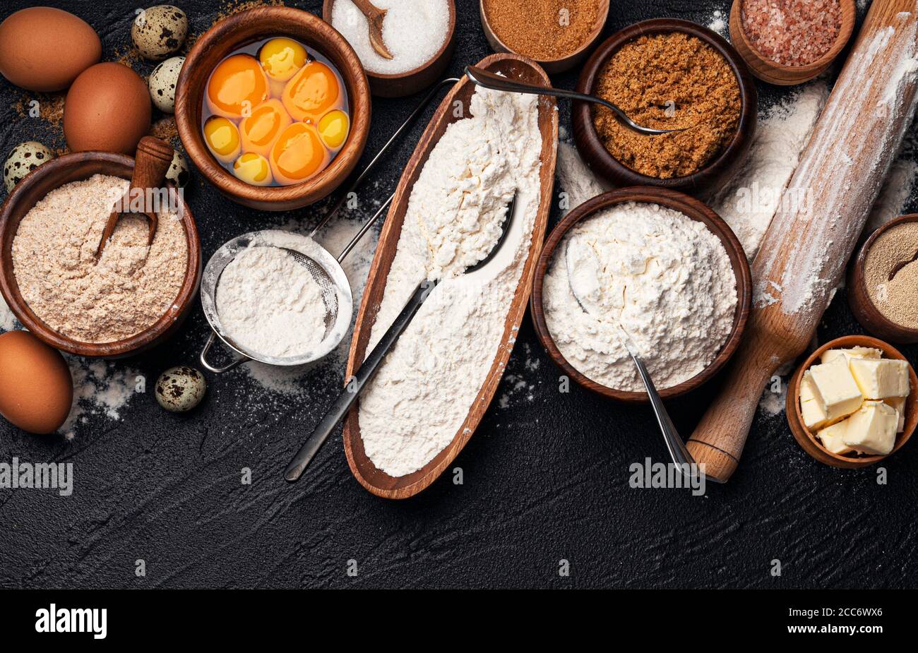 Baking ingredients on black background, top view Stock Photo - Alamy