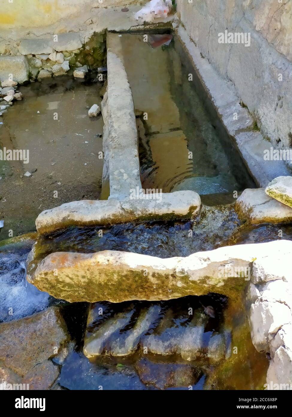 An ancient, stone-carved water trough for animals Stock Photo - Alamy