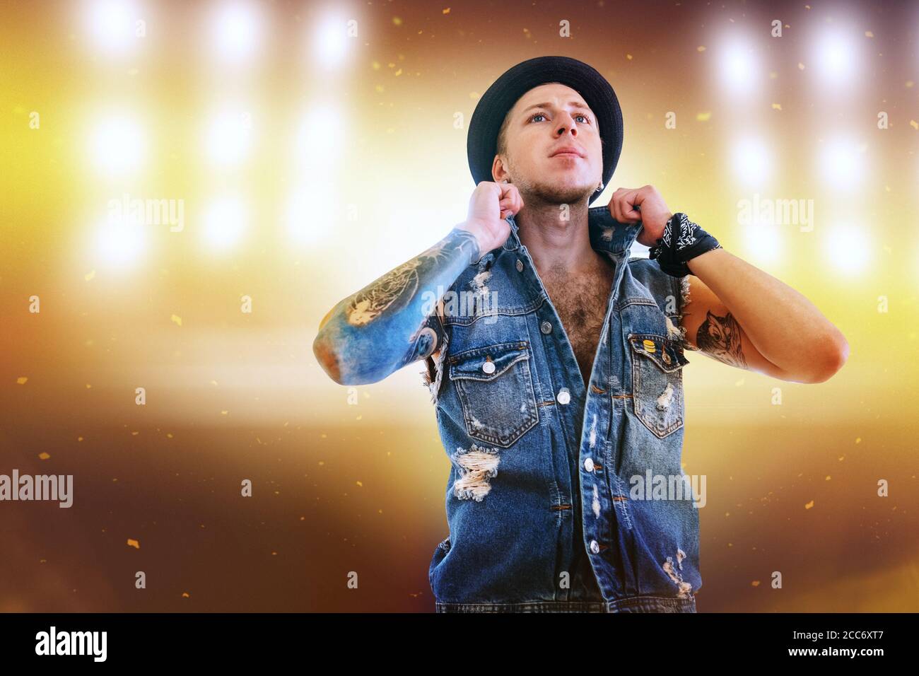 Jeans dressed Dancer teenager man in denim jacket posing on the dance ...