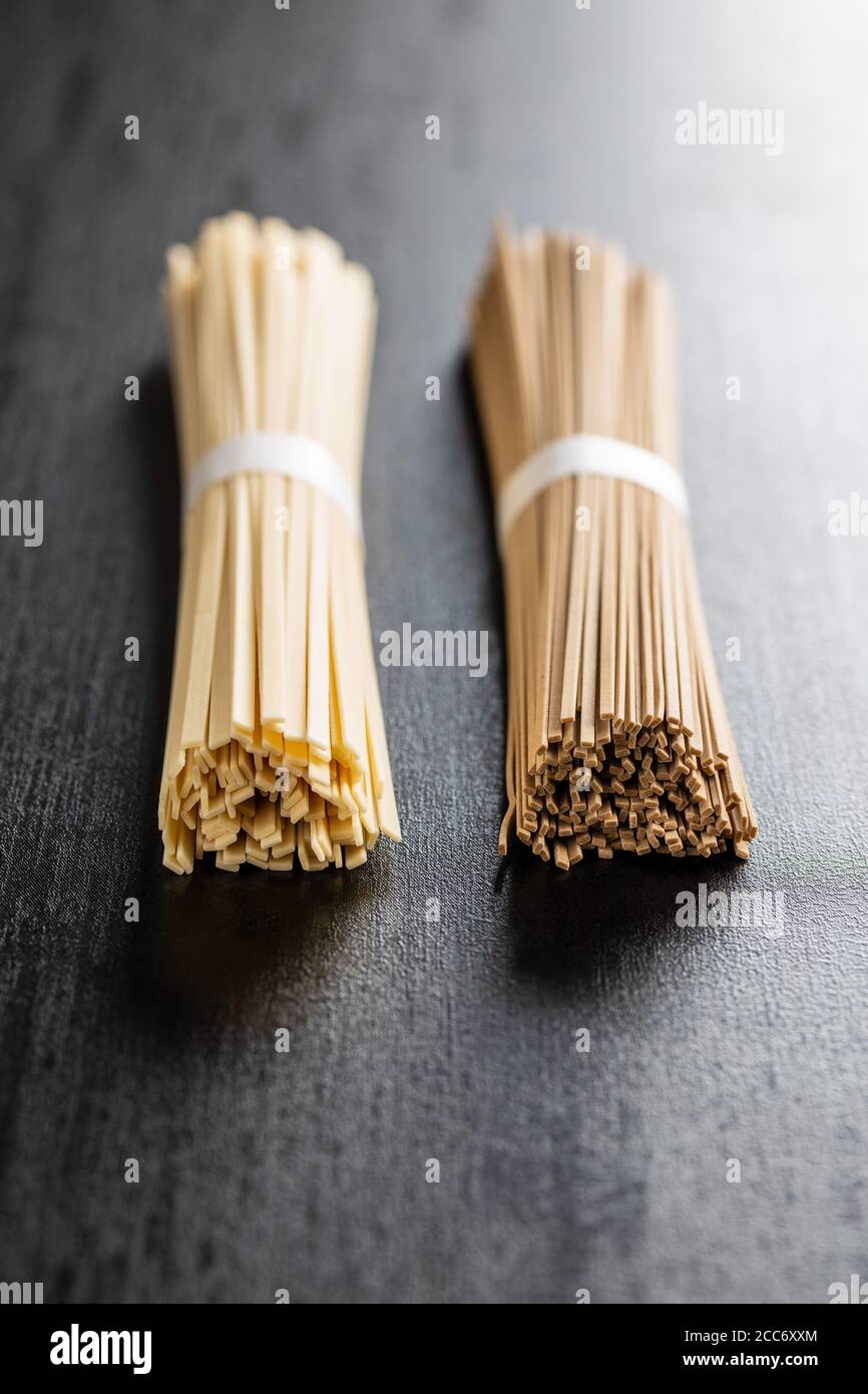 Uncooked soba and udon noodles. Traditional Japanese noodles on black ...
