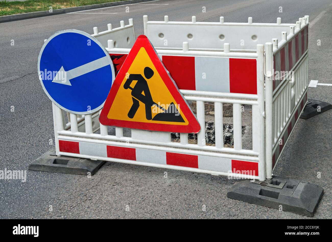 Plastic fence with warning signs during road repair Stock Photo - Alamy