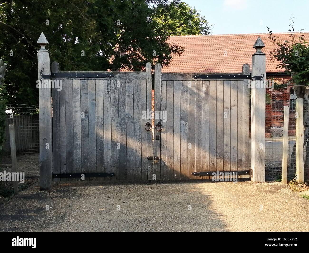 Rustic old wooden gate in brick wall. Old wooden door in UK Stock Photo ...