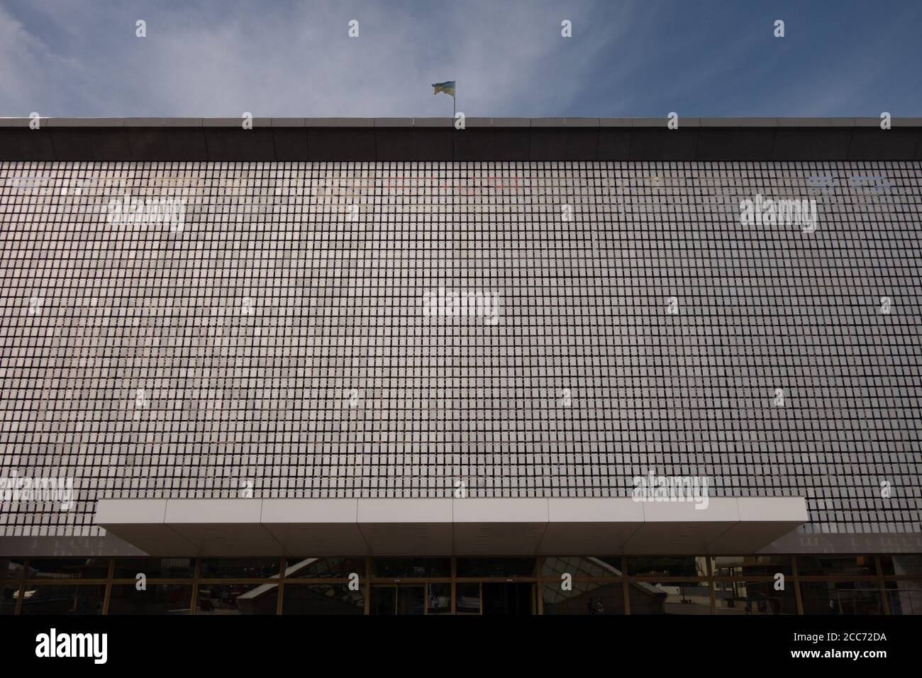 The kinetic facade of the building. Loose metal plates swing in waves ...