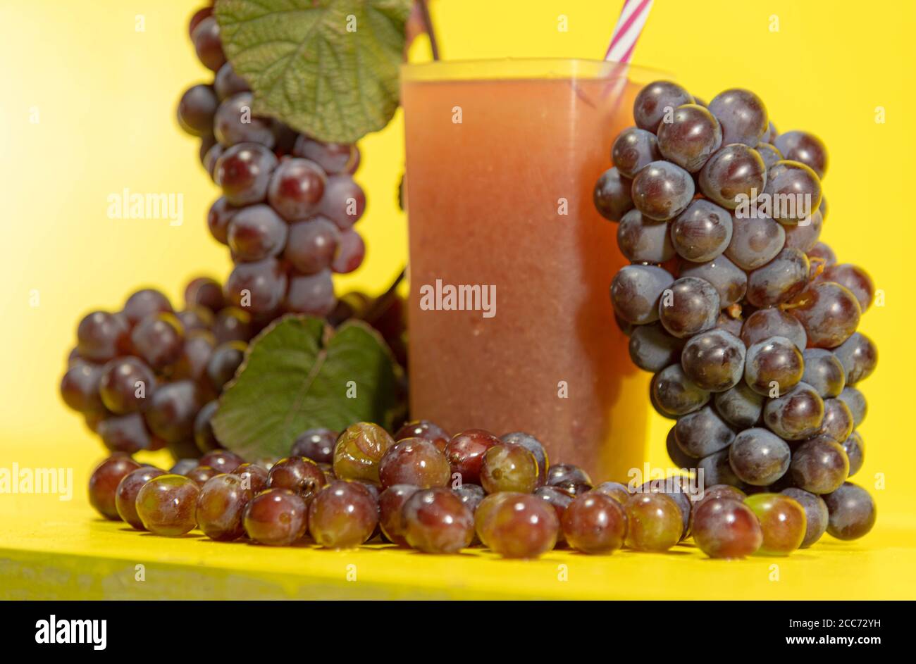 Bunches of pink grape. Fruit juice. Energetic and refreshing drink ...
