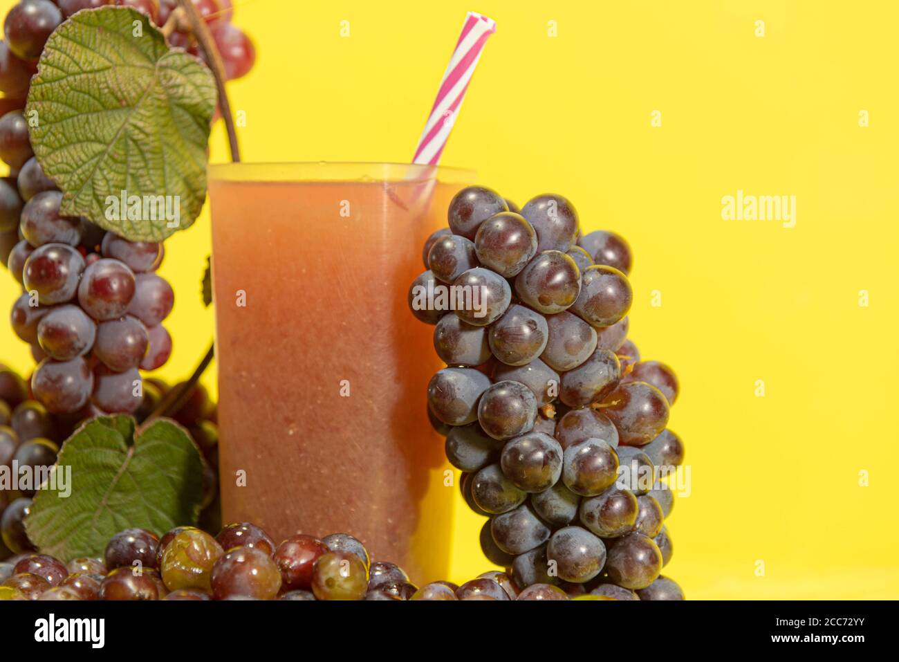 Bunches of pink grape. Fruit juice. Energetic and refreshing drink ...