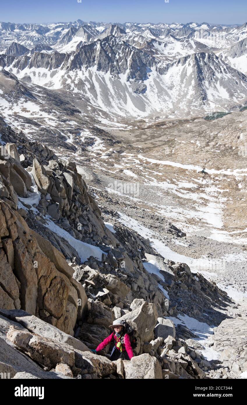 woman climbing up the steep third class upper headwall of the Southwest ...
