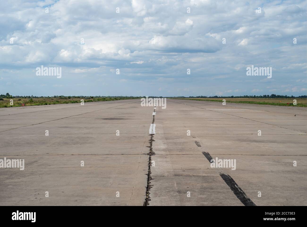 Military transport airfield Kryvyi Rih. Empty runway strip and cumulus ...