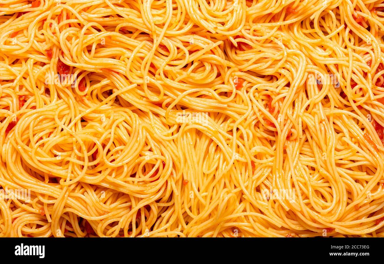 Above view with cooked spaghetti with tomato sauce. Background with a ...