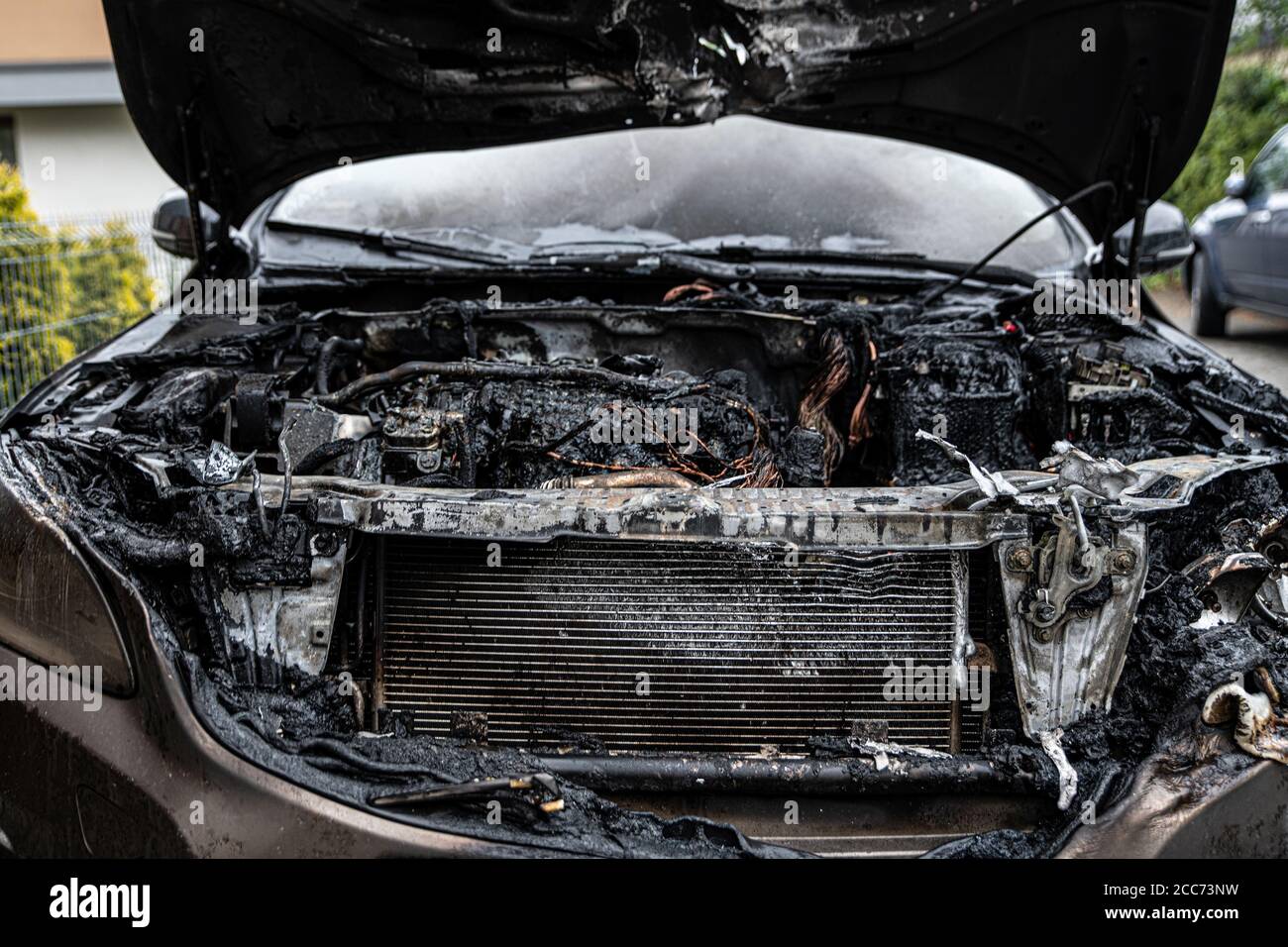 Destroyed car after fire. Burnt modern car engine Stock Photo - Alamy