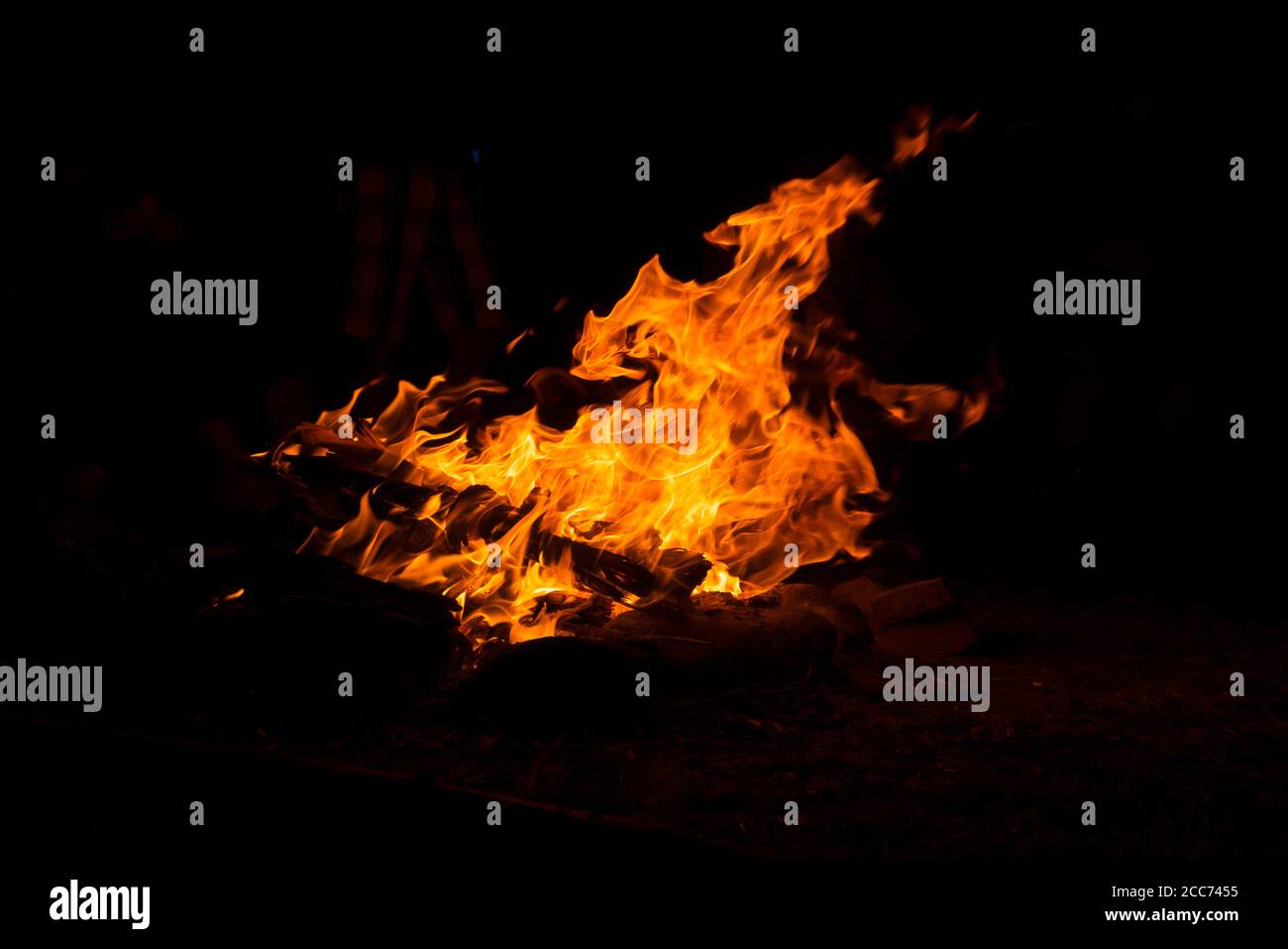 Camping fire in total darkness during night and nobody around Stock ...