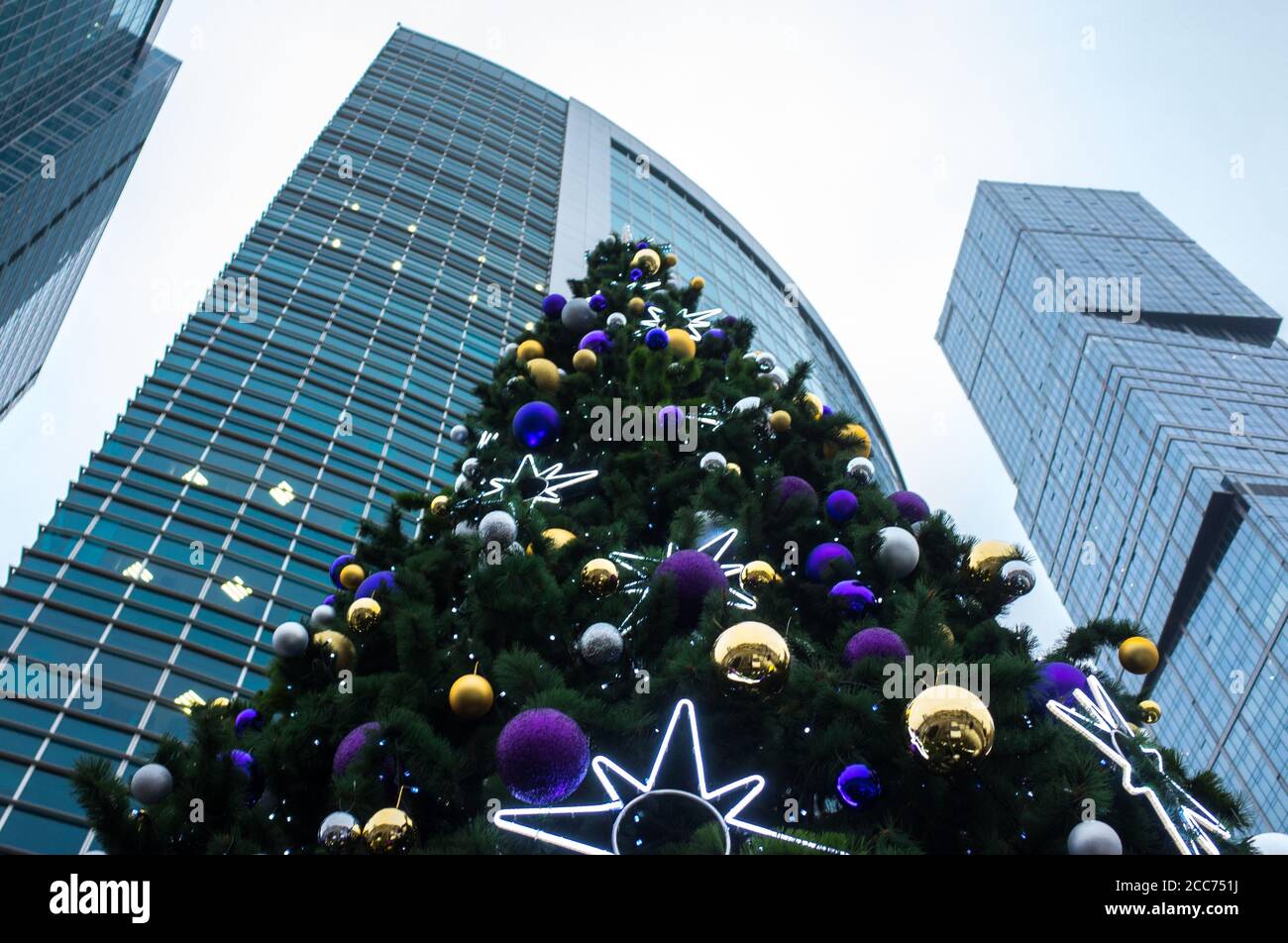Christmas tree on the background of a skyscraper covered in fog Stock ...