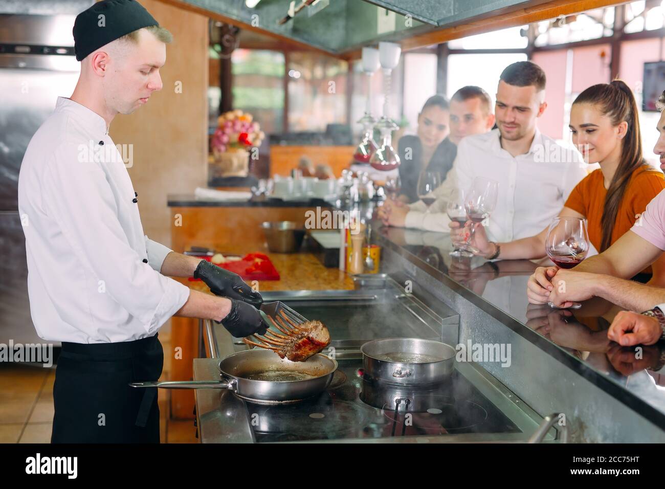 The chef prepares food in front of the visitors in the restaurant Stock ...