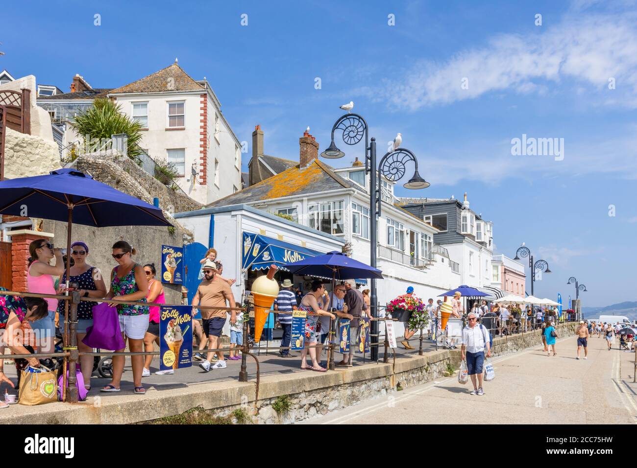 Busy Marine Parade seafront promenade at Lyme Regis, a popular seaside ...