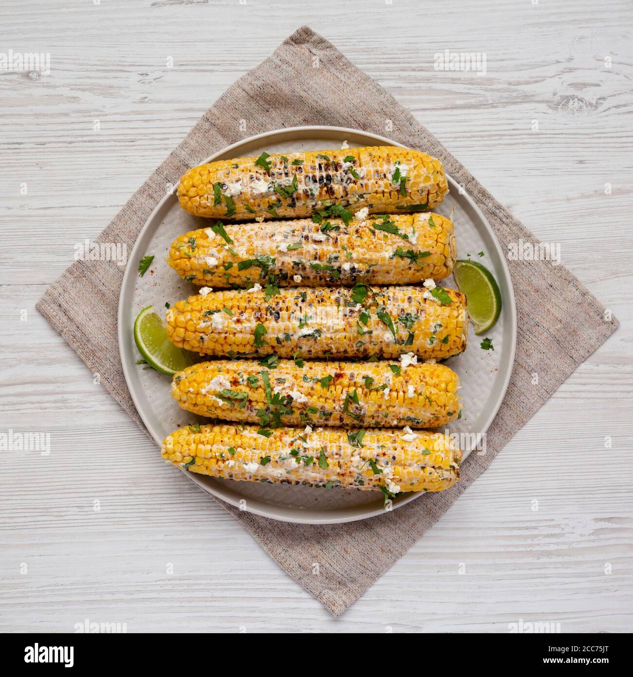 Homemade Elote Mexican Street Corn on a plate on a white wooden ...