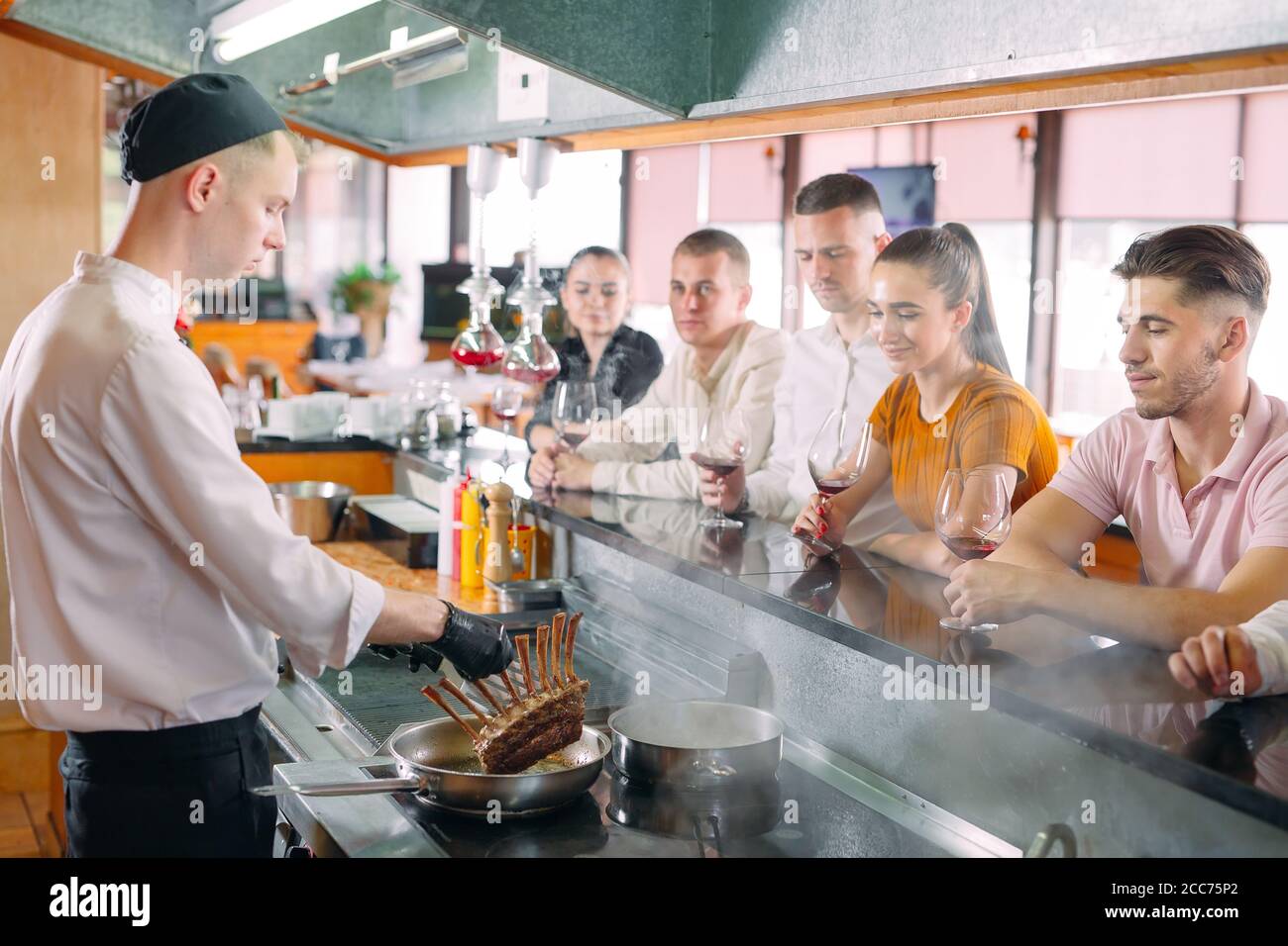 The chef prepares food in front of the visitors in the restaurant Stock ...