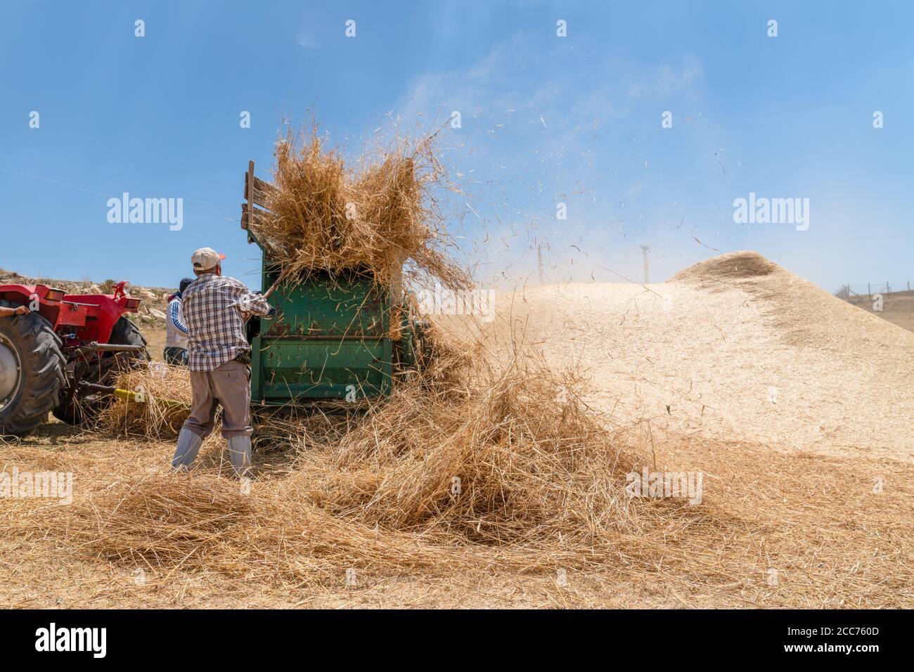 Traditional haymaking with thresher machine Stock Photo - Alamy