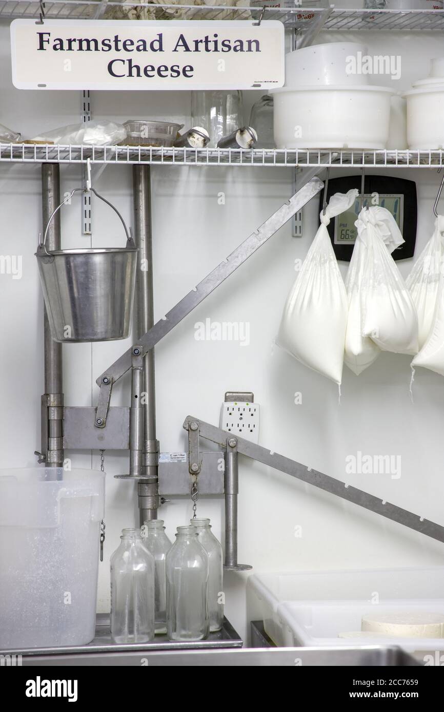 Cheesemaking supplies along with Chevre hanging in cheese cloth bags in ...