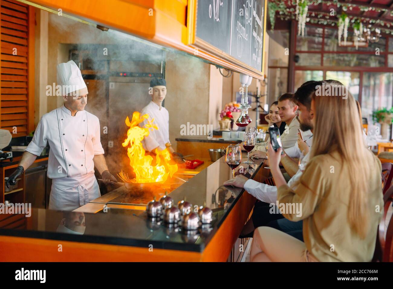The chef prepares food in front of the visitors in the restaurant Stock ...