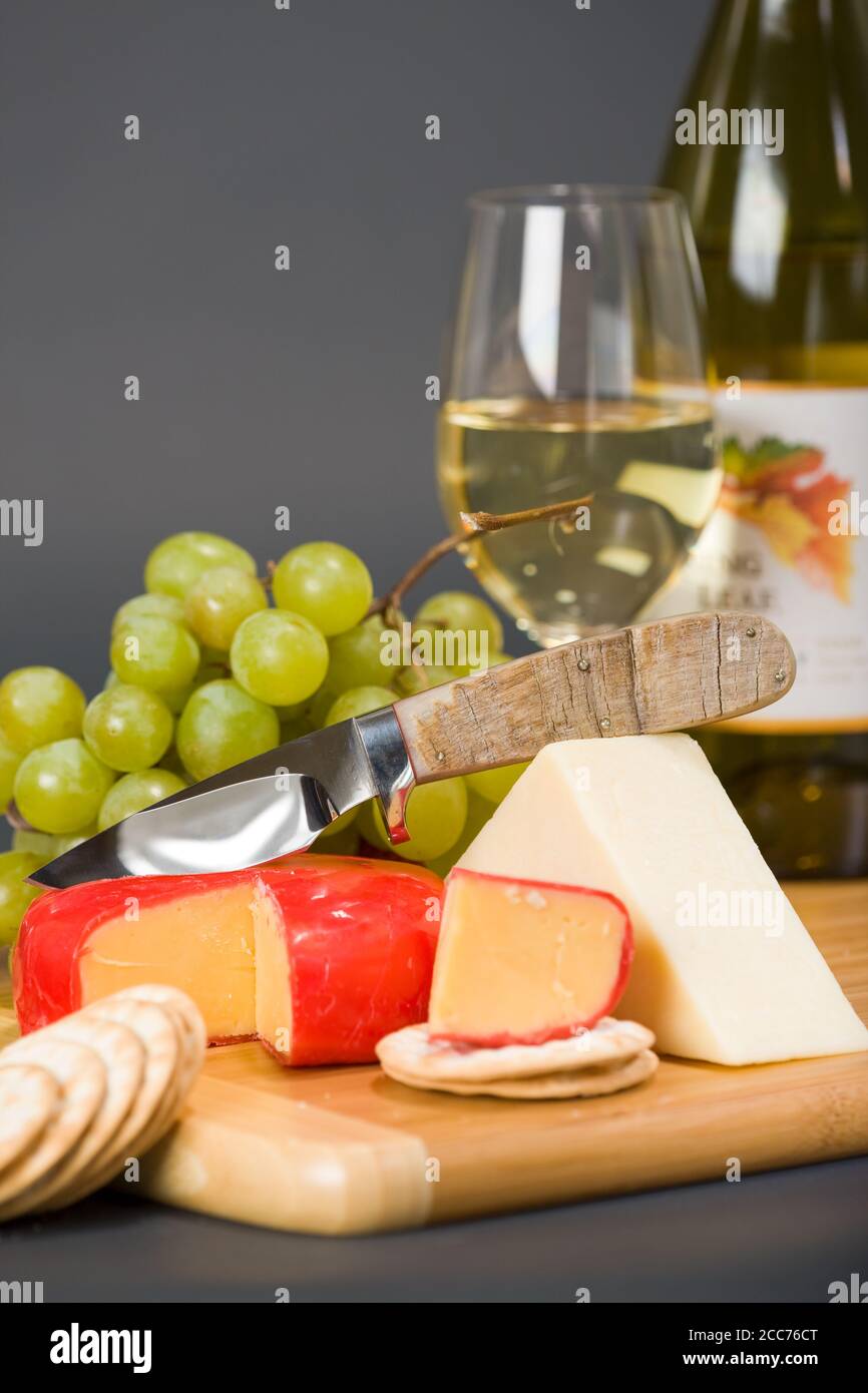 Gouda cheese, Beecher's Flagship cheese, knife, water crackers, glass ...