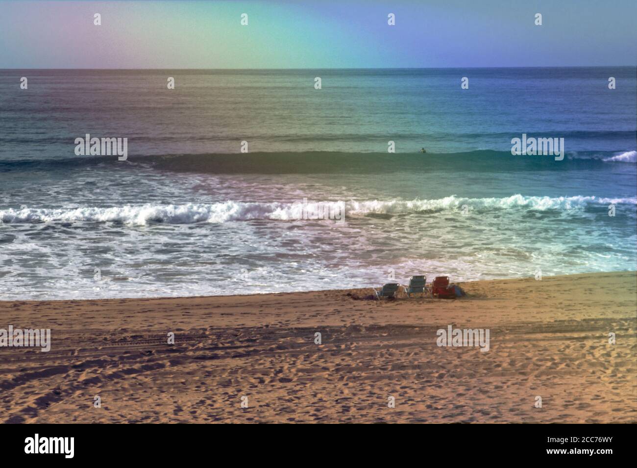 Rainbow over the beach Stock Photo - Alamy