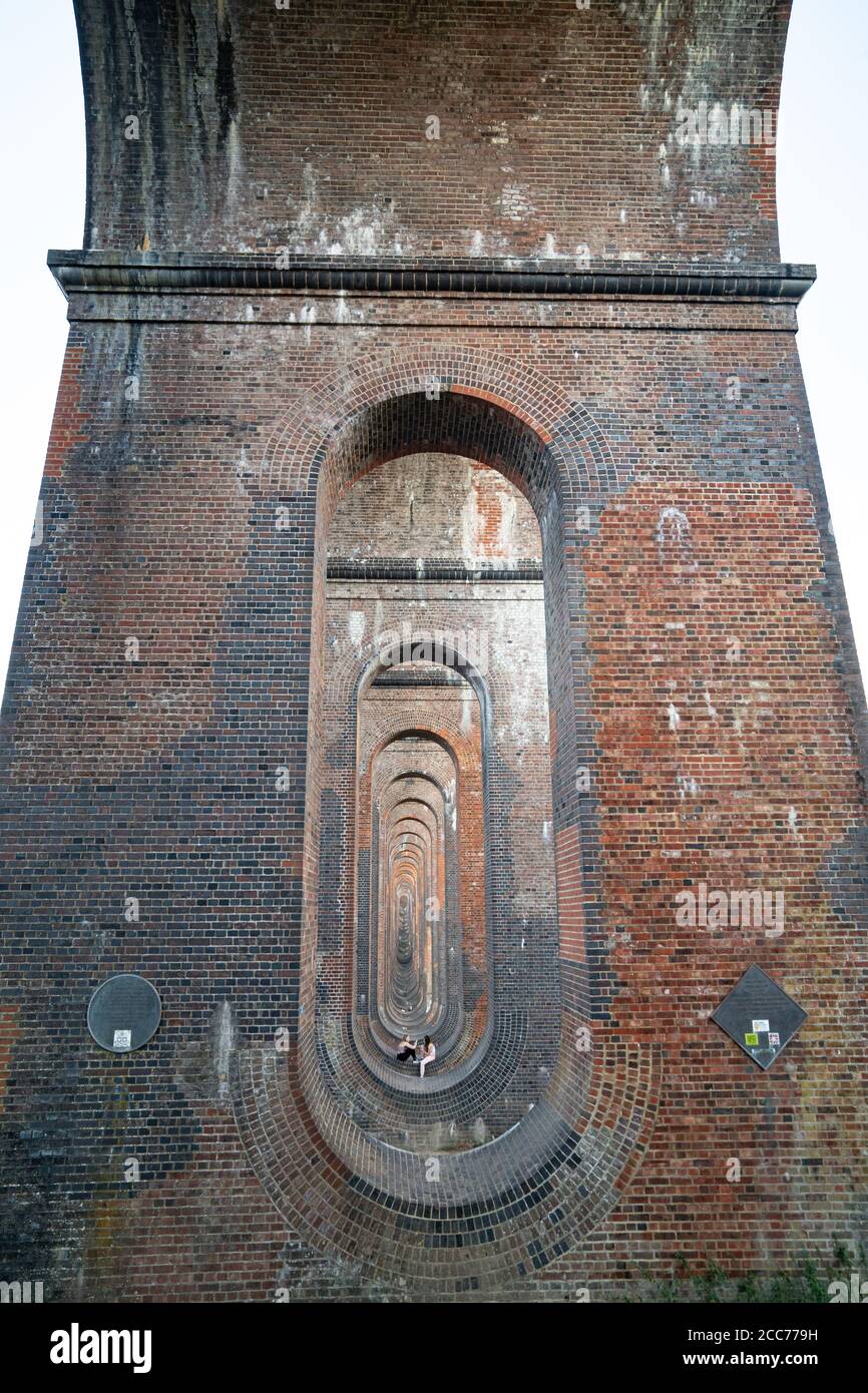 Young people under the Ouse Valley Viaduct (Balcombe Viaduct) carrying ...