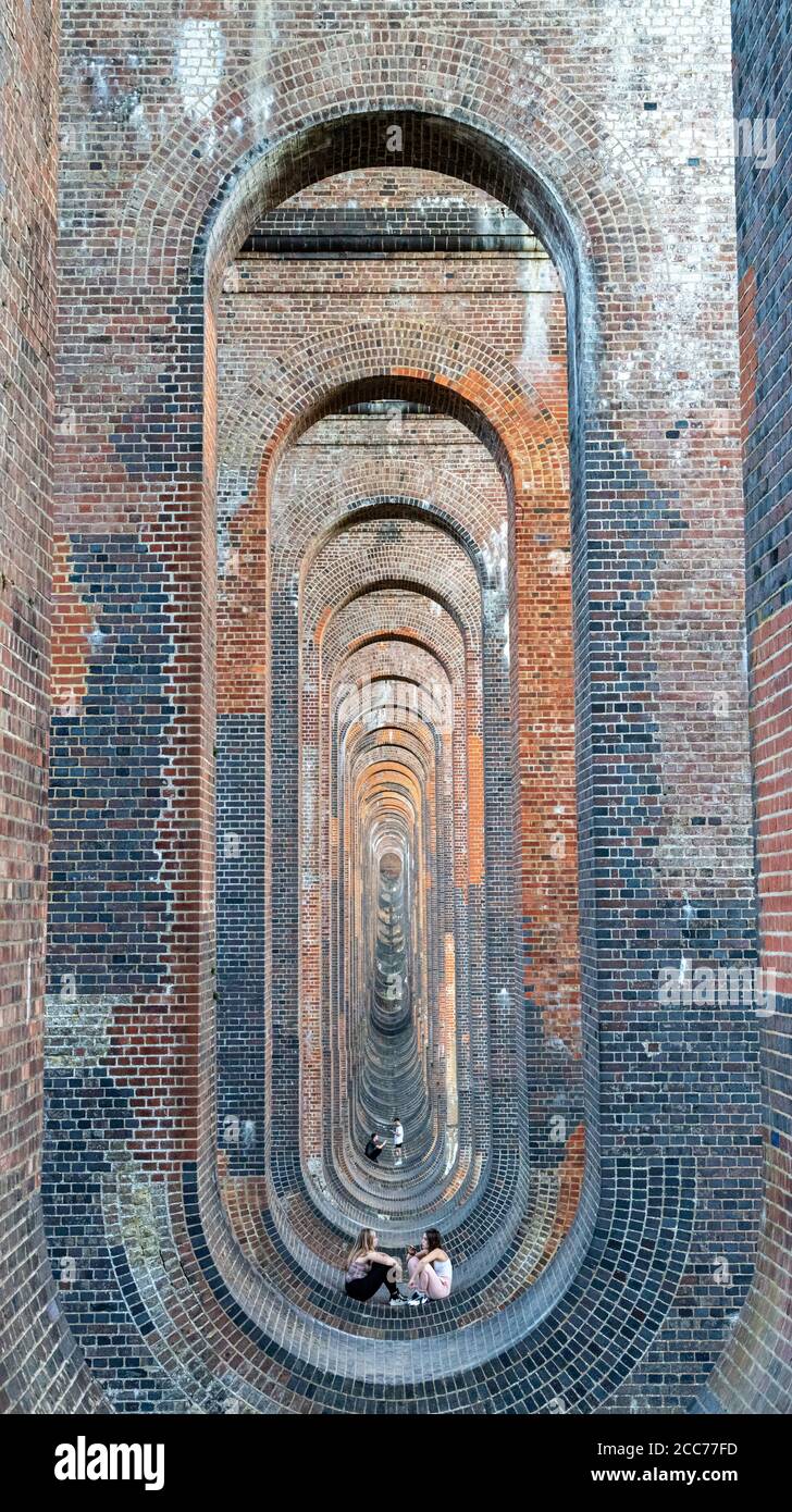 Young people under the Ouse Valley Viaduct (Balcombe Viaduct) carrying ...