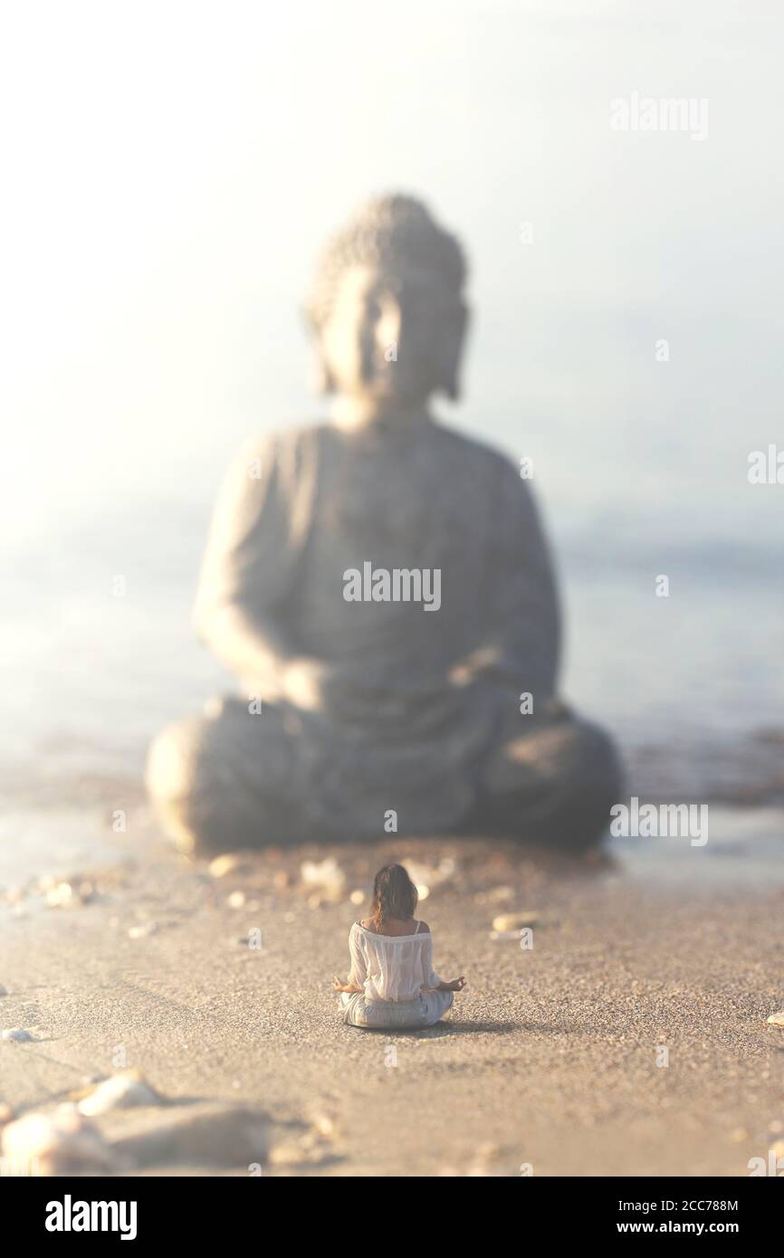 woman makes yoga exercises in front of the Buddha statue Stock Photo ...