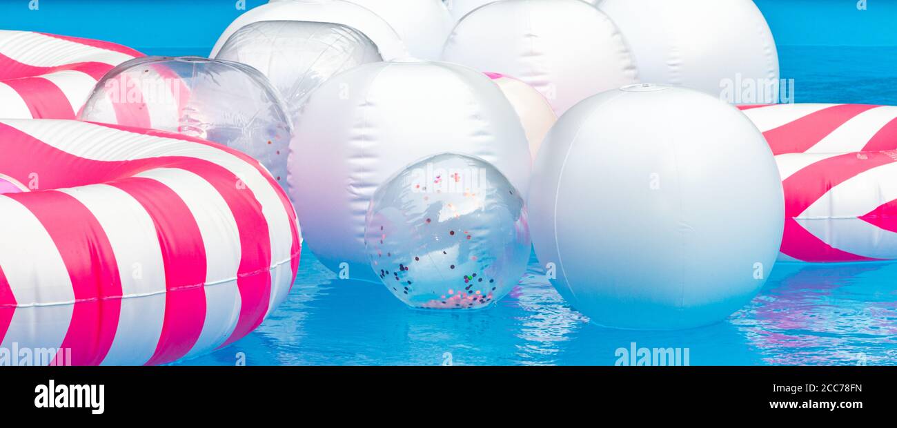 beach balls floating in a pool Stock Photo - Alamy