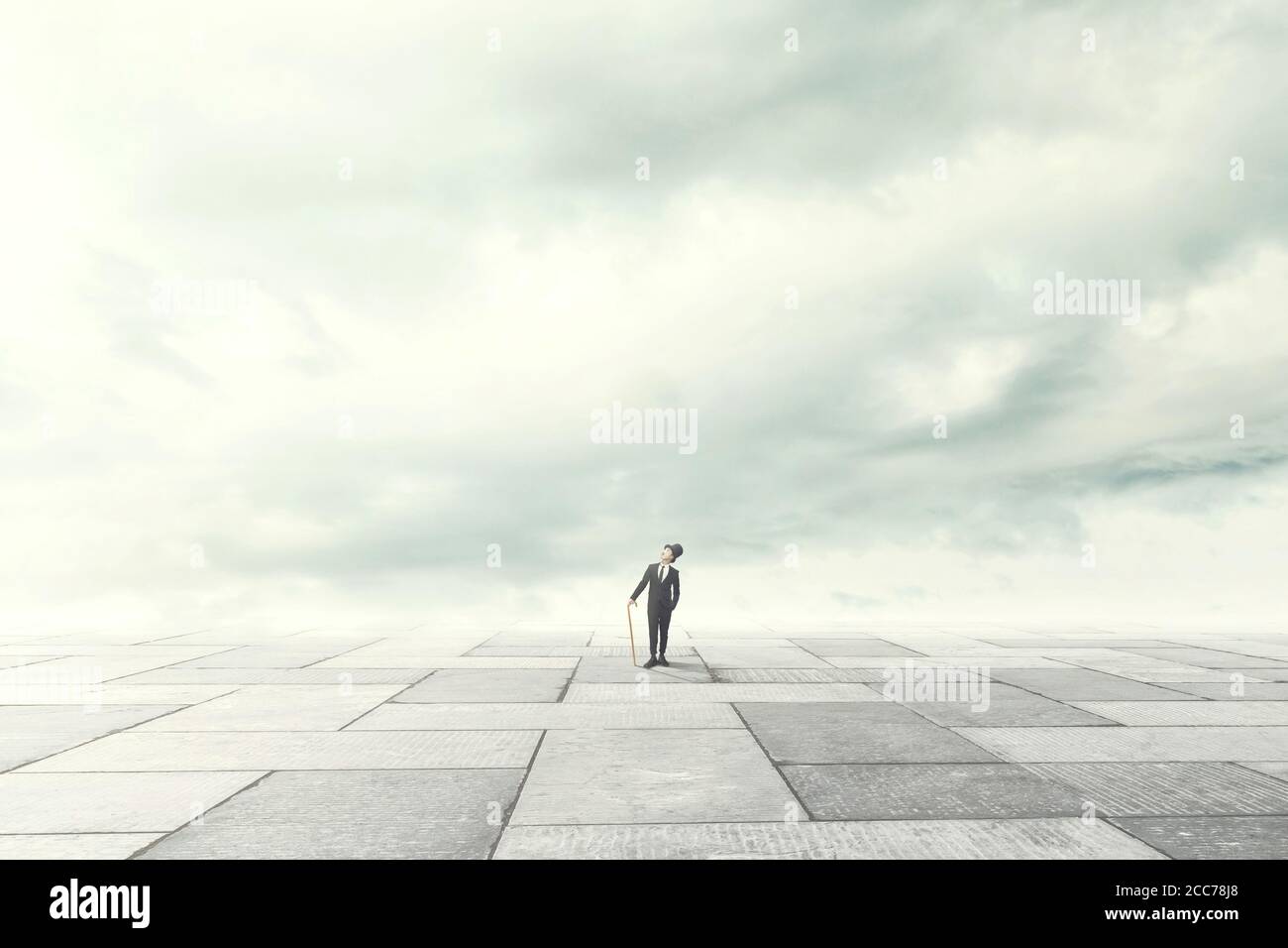 lonely man looks at the cloudy sky above him in a surreal atmosphere ...
